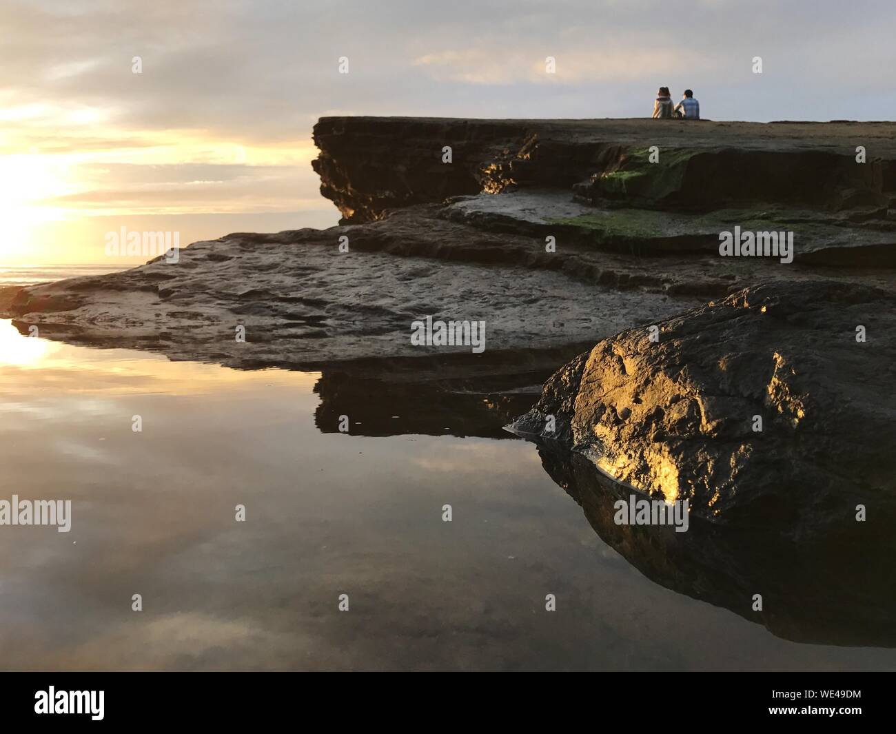 Two women sitting rock sunset hi-res stock photography and images - Alamy