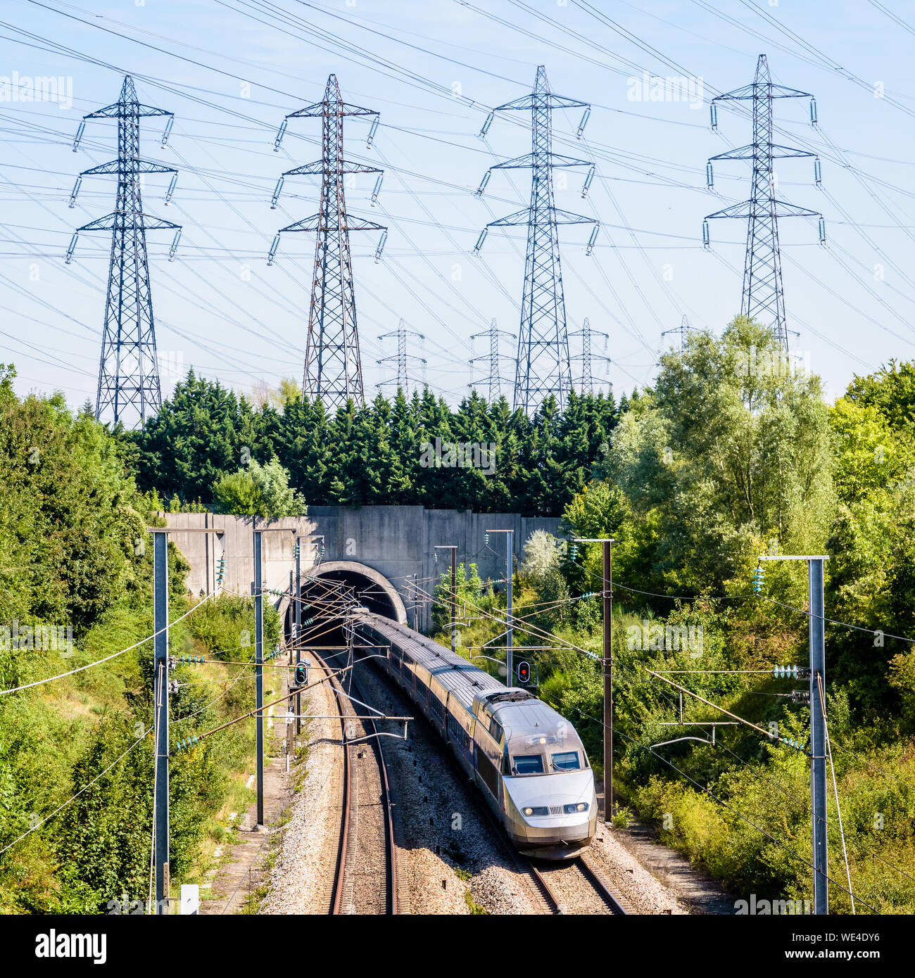 A TGV high-speed train in Atlantic livery is coming out of a tunnel ...