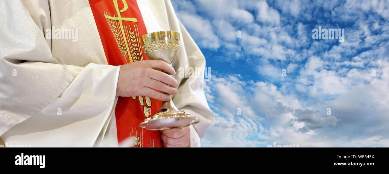 Priest with chalice celebrate mass and empty place for text against ...