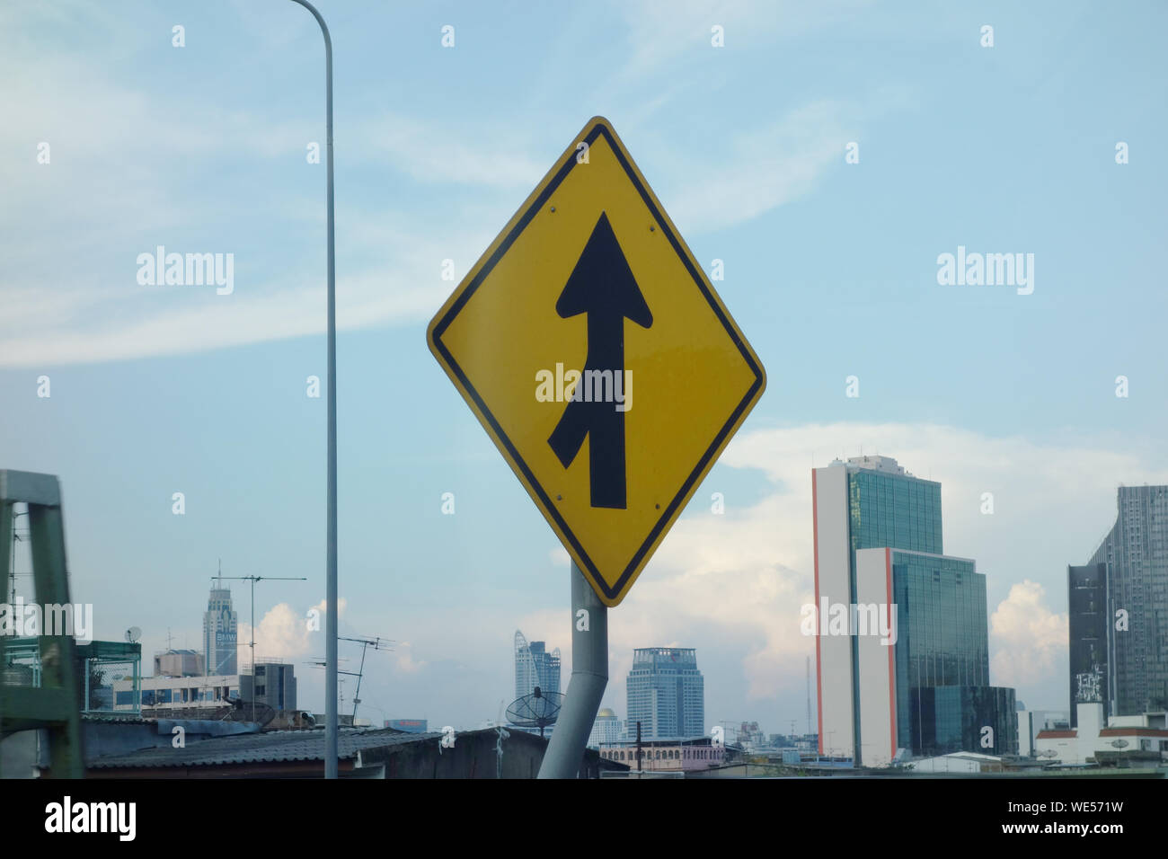 Traffic Arrow Sign With Cityscape In The Background Stock Photo - Alamy