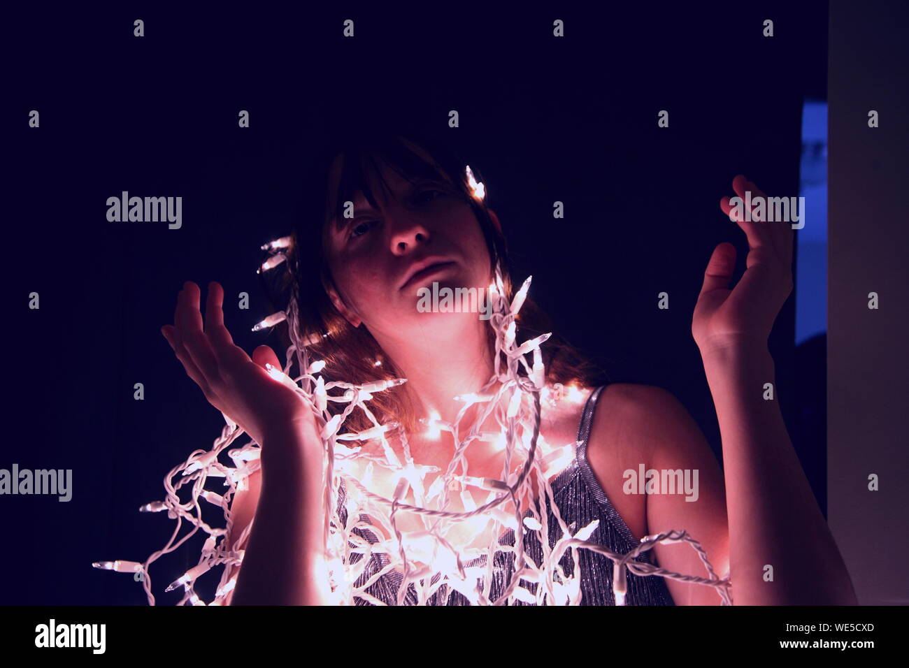 Teenage Girl With Illuminated String Light In Darkroom Stock Photo - Alamy