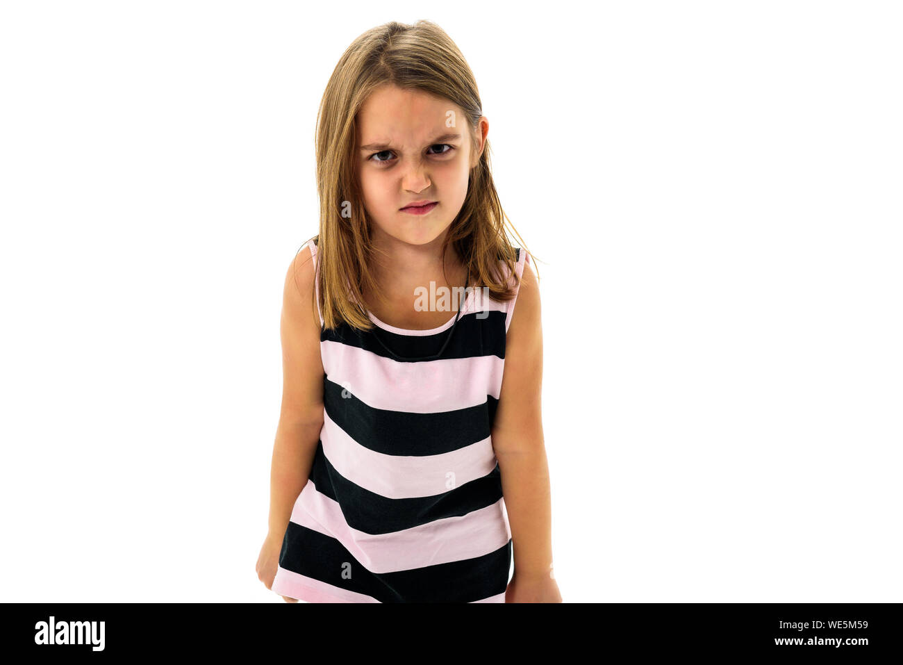 Portrait Of Angry Girl Standing Against White Background Stock Photo ...