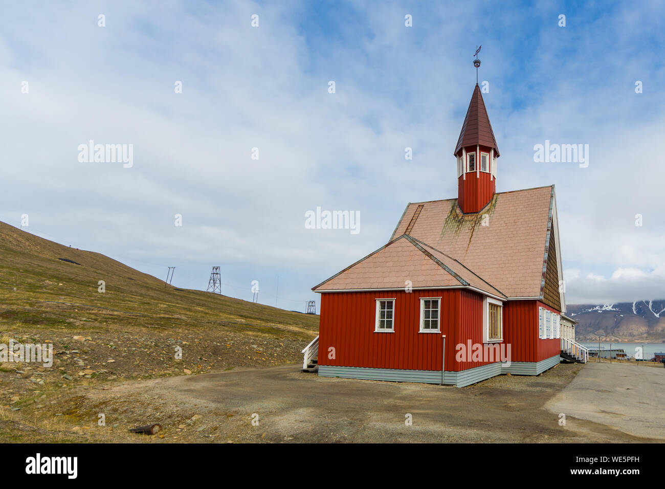 red Svalbard church in Longyearbyen, cloudy blue sky, sunshine Stock ...