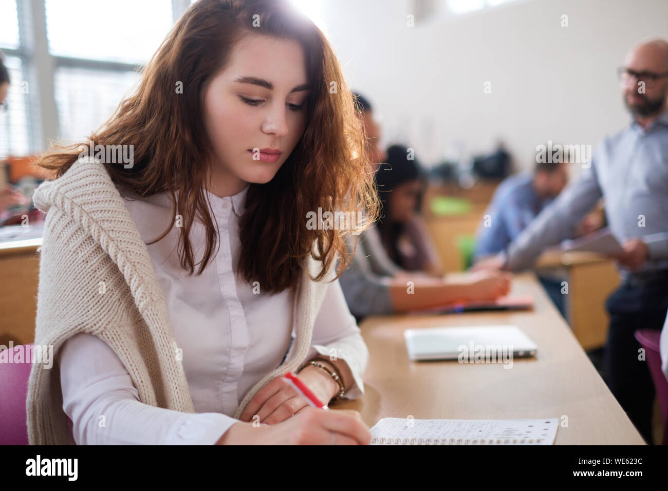 Beautiful girl taking notes in multinational group of students in an ...