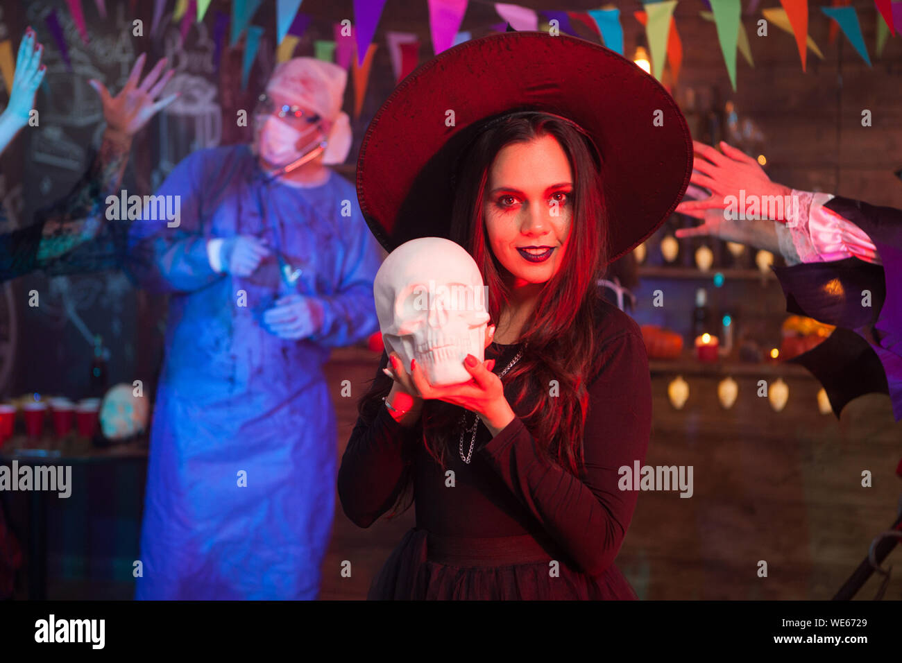 Portrait of beautiful young woman dressed up like a witch for halloween ...
