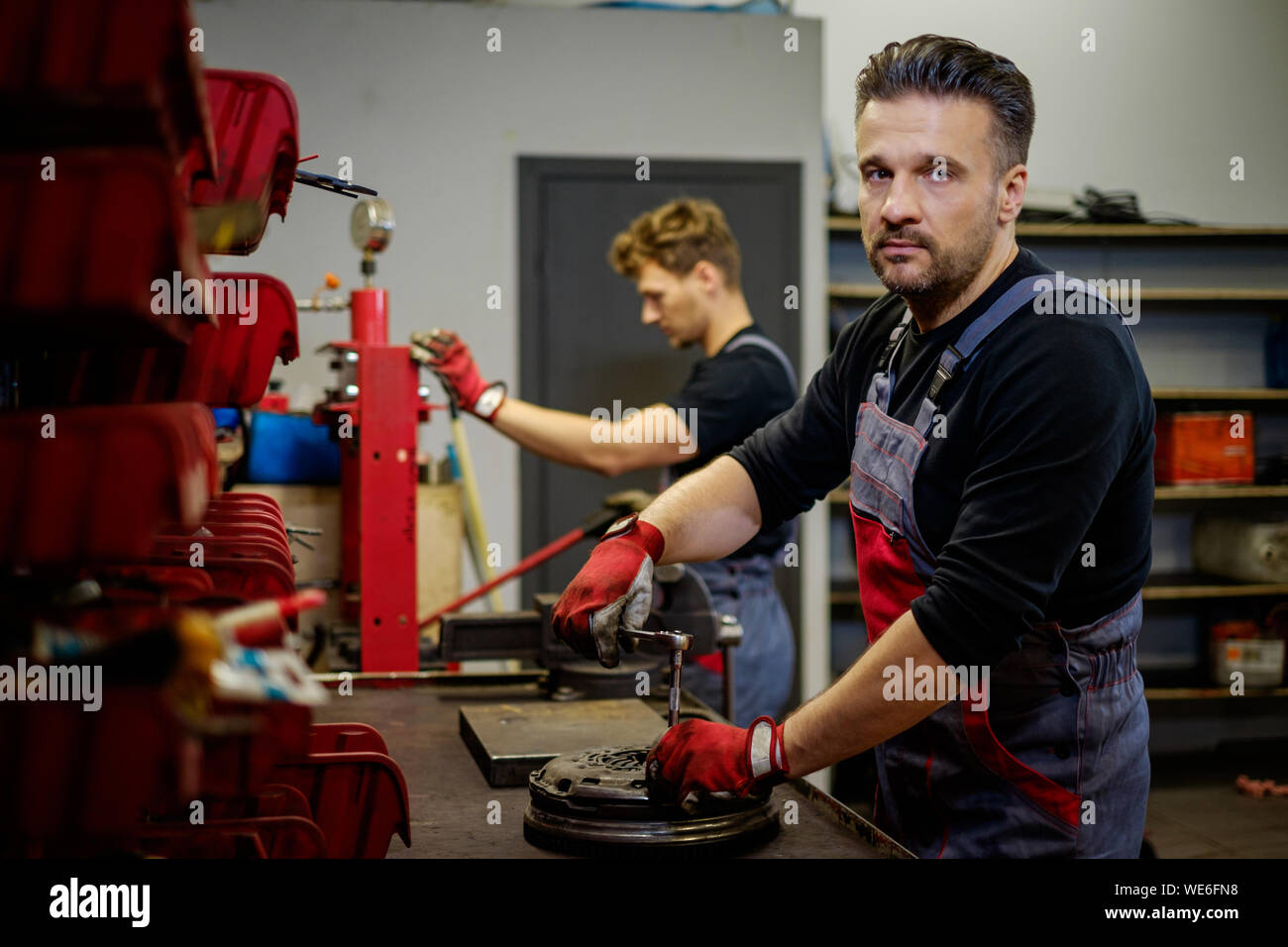 Car mechanics inspecting headlights in a workshop Stock Photo - Alamy