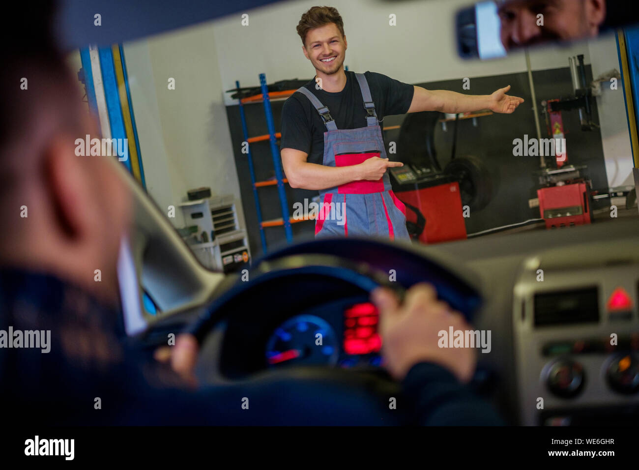 Mechanic welcomes new client to his auto repair service Stock Photo - Alamy