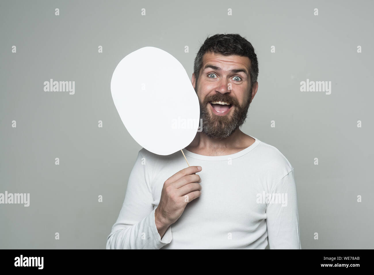 man with long beard on happy face with paper nameplate on grey ...