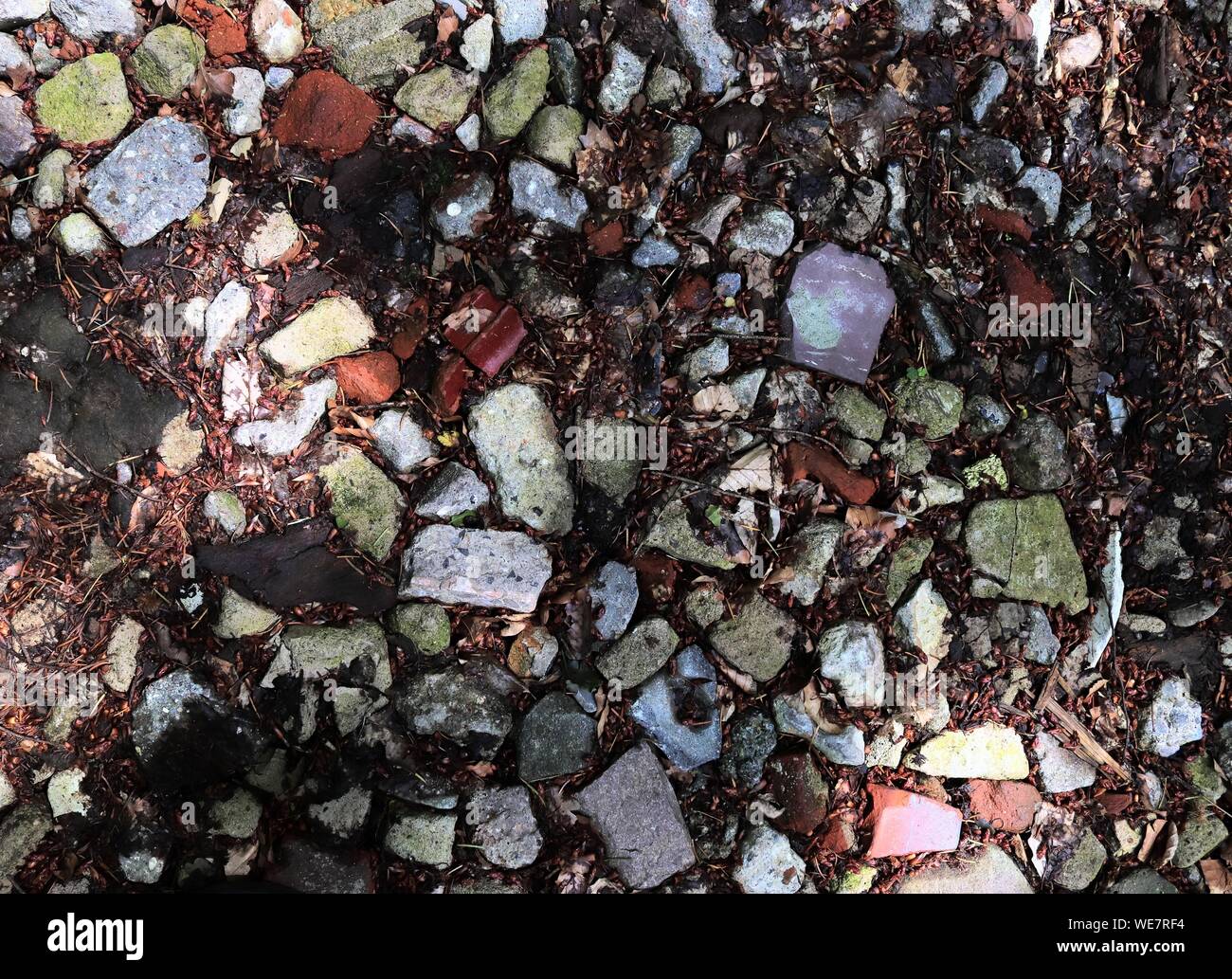 Detailed close up view on pebbles and stones on a gravel ground texture ...