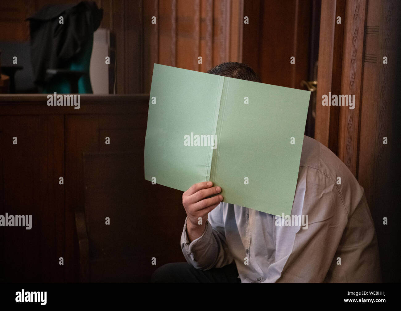 Berlin, Germany. 30th Aug, 2019. The defendant holds a paper in front ...