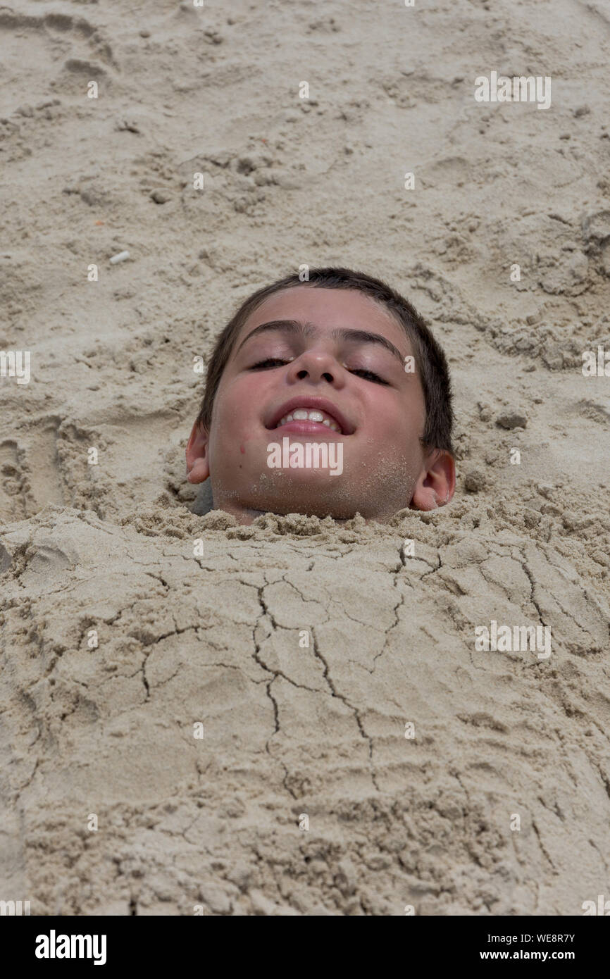 People buried in sand hi-res stock photography and images - Alamy
