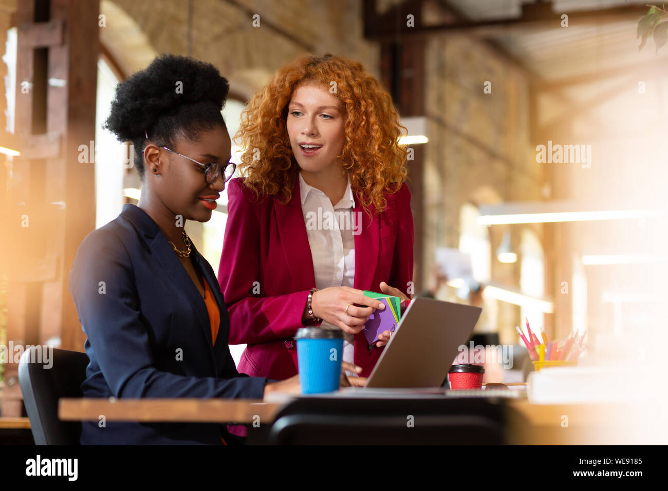 Interior designer giving some orders to her secretary Stock Photo - Alamy