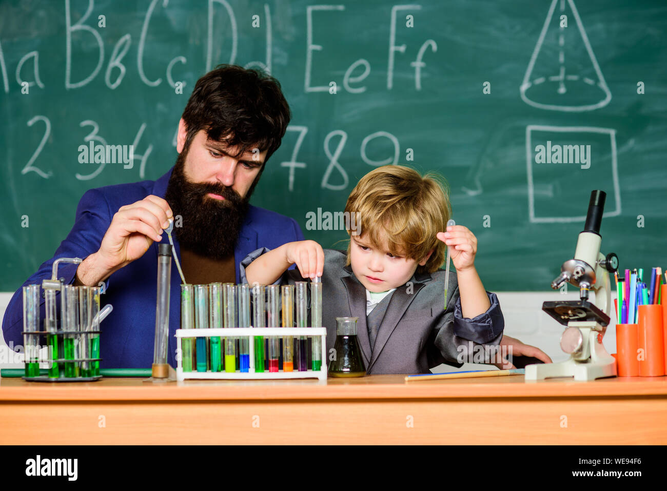 Little kid learning chemistry in school laboratory. Back to school ...