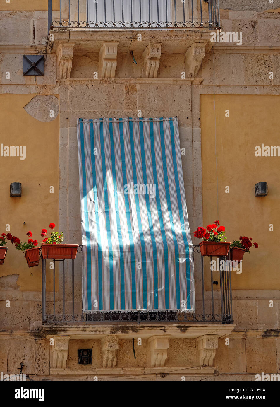 fabric window shade, striped, draped over railing, privacy, potted ...