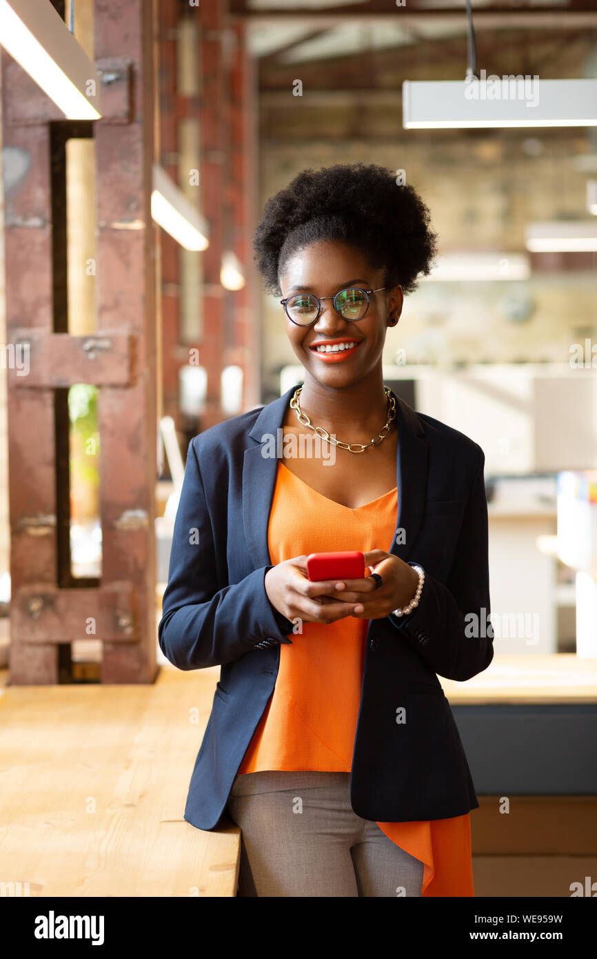 Young stylish curly African-American woman smiling broadly Stock Photo ...