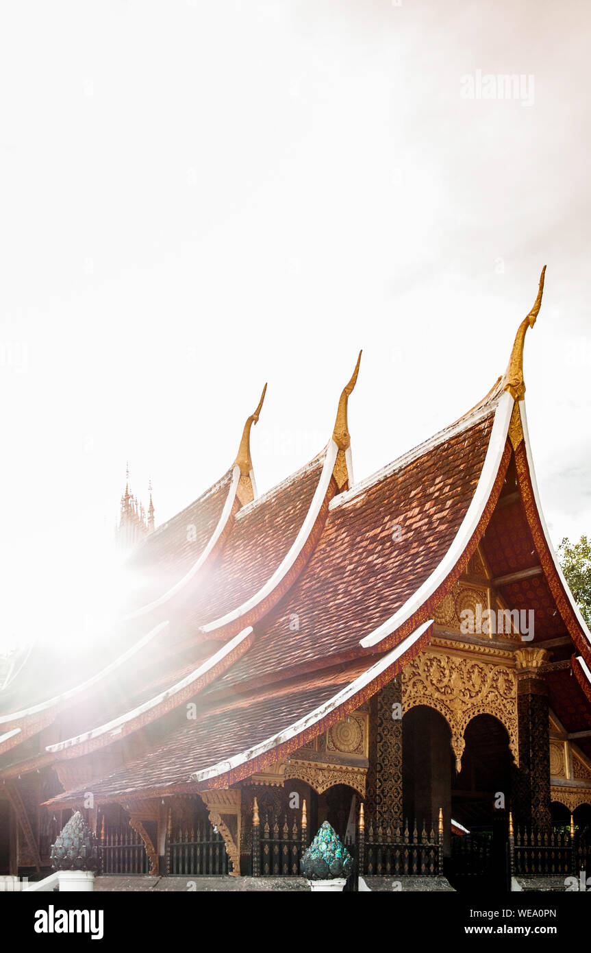 Lao style Temple roof against sunlight, Luang Prabang, Laos. Wat Xieng ...