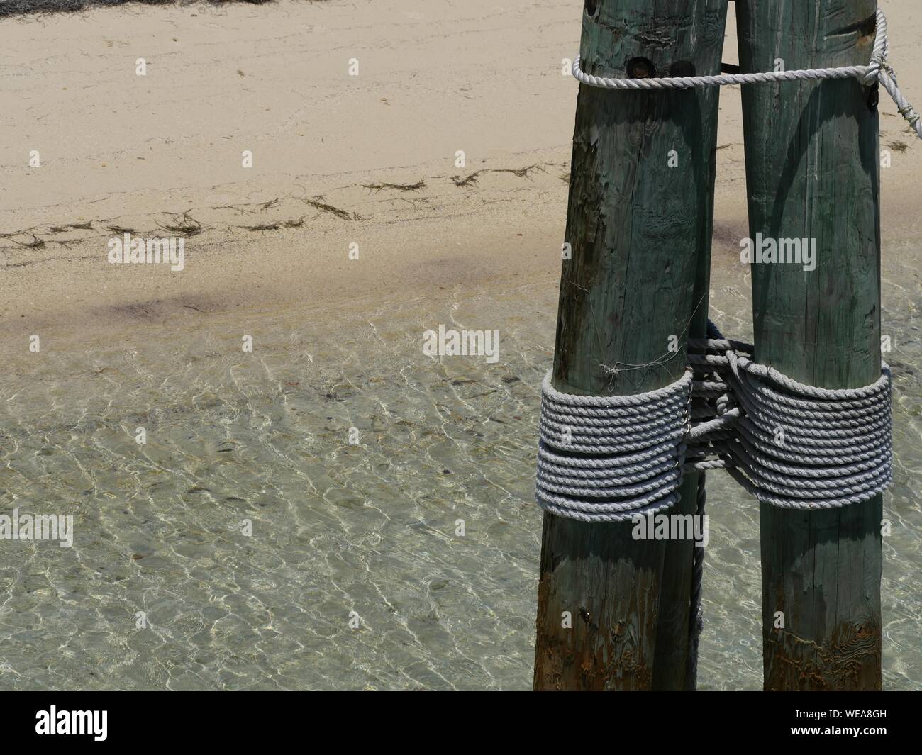 Old rope tied wooden pole hi-res stock photography and images - Alamy