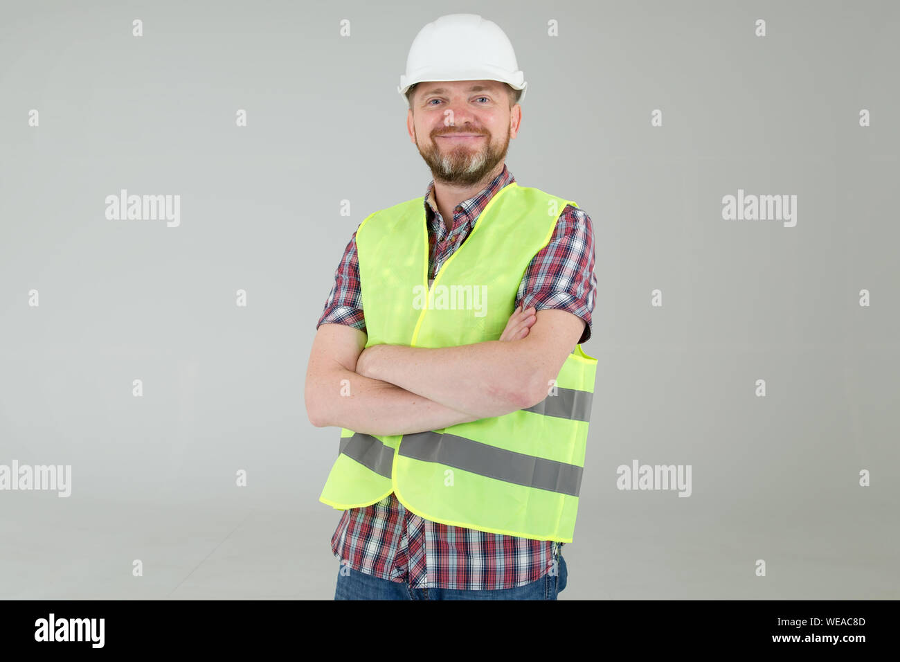 Middle-aged man with a beard, profession engineer builder standing on a ...