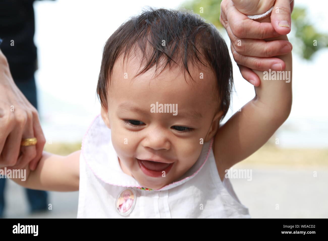 Baby looking down hands hi-res stock photography and images - Alamy