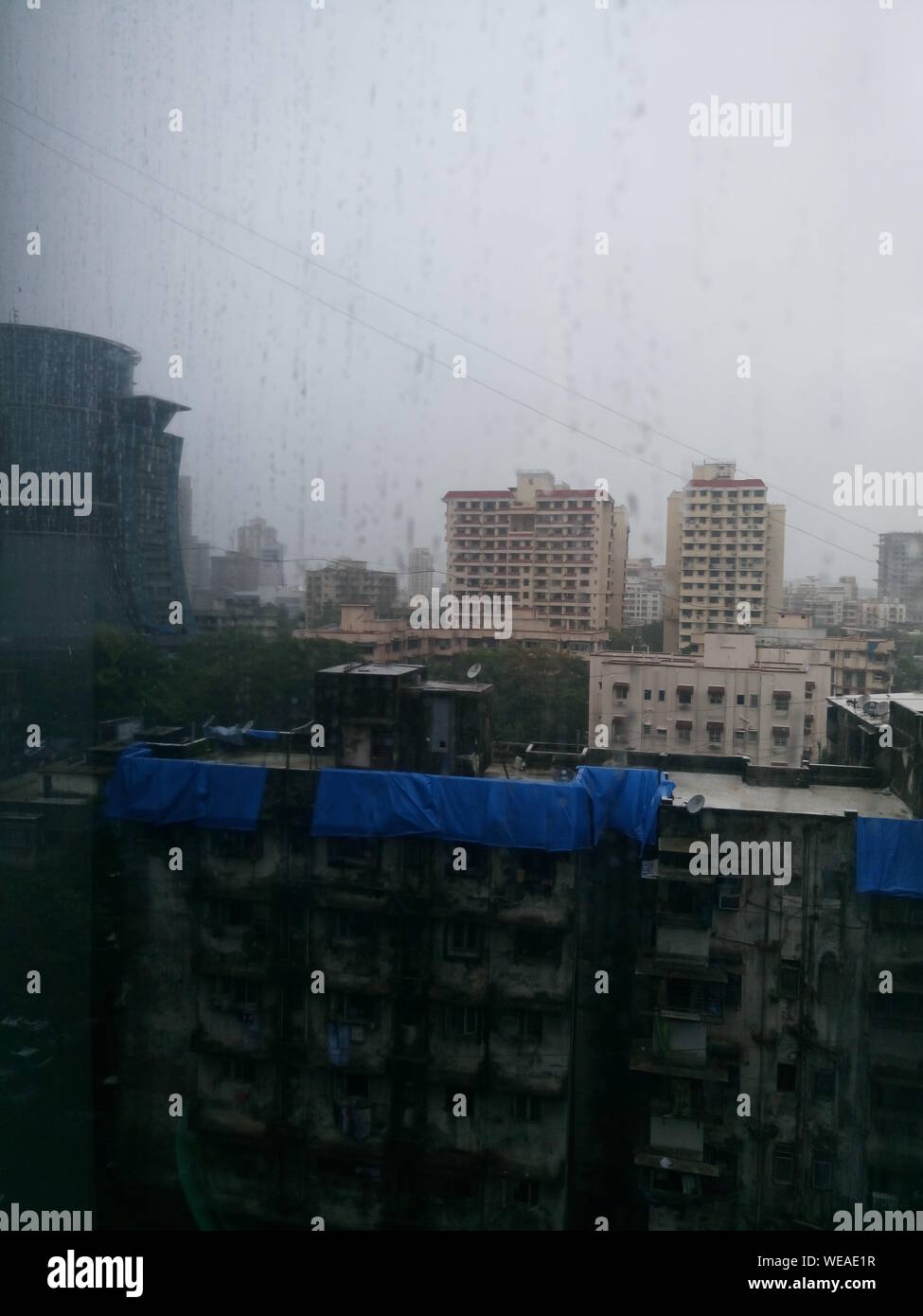 Tall buildings in the rain hi-res stock photography and images - Alamy