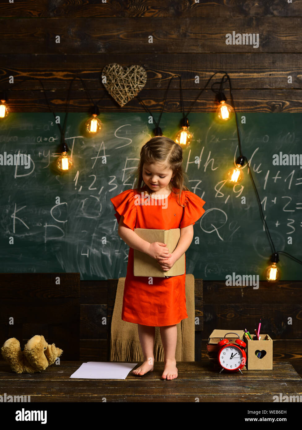 case. Education at the elementary school - pupil writing in notepad at ...