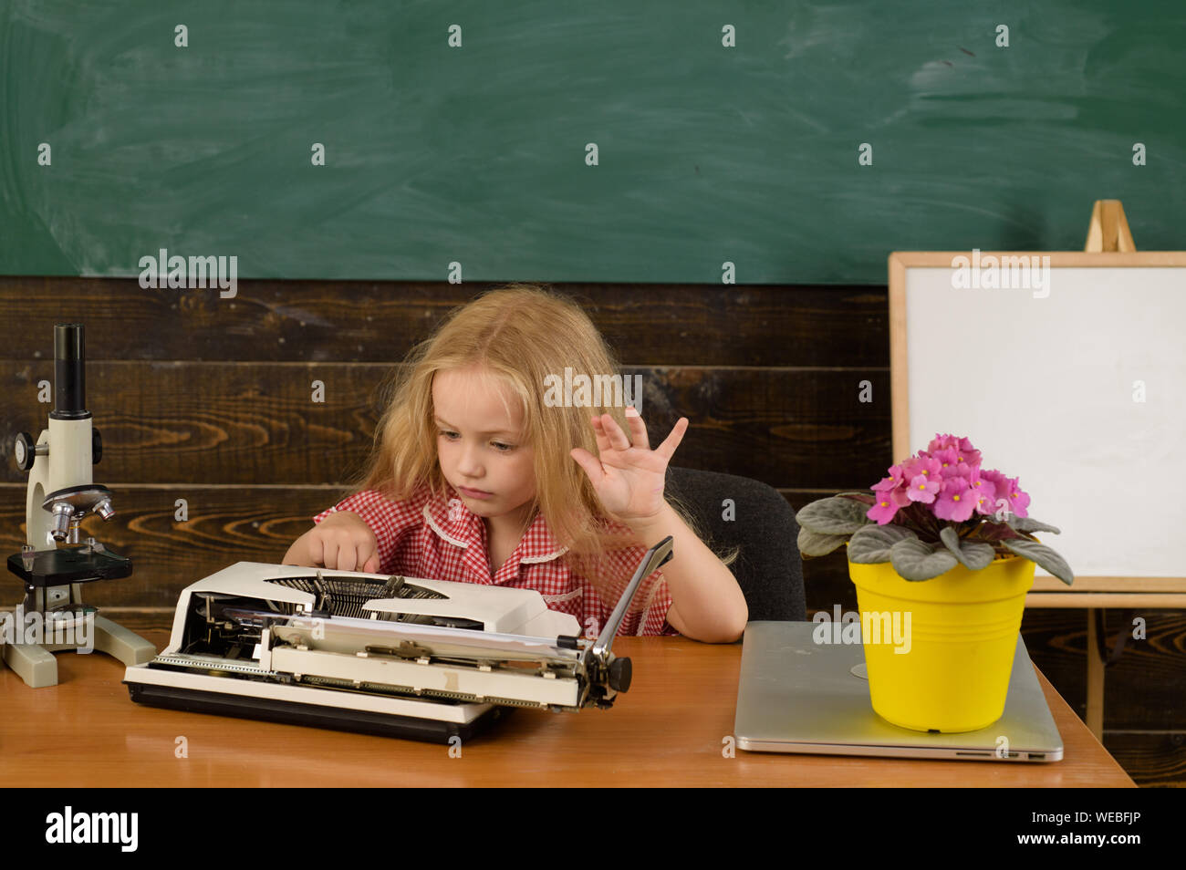 Schoolchild learn using typewriter in school. Little schoolchild at ...