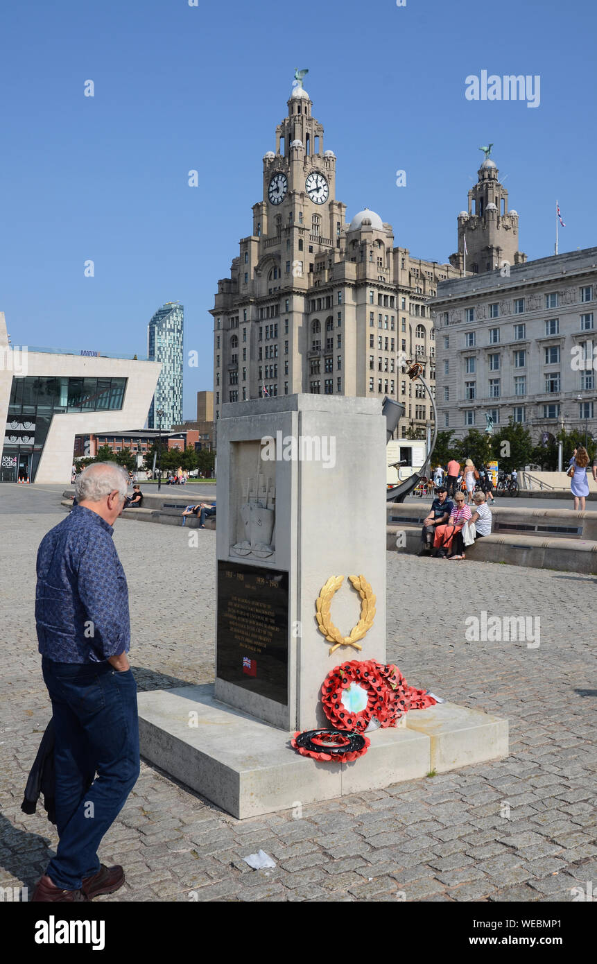 Man looking at Merchant Navy war memorial near the Liver Building and ...