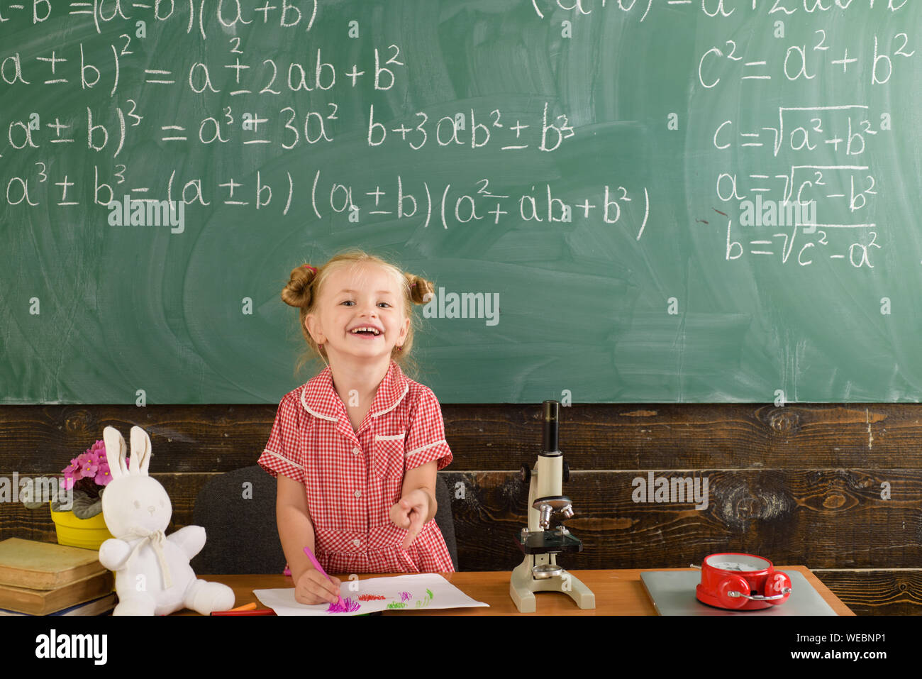 Schoolgirl smile on classroom chalkboard. Happy schoolgirl have lesson ...