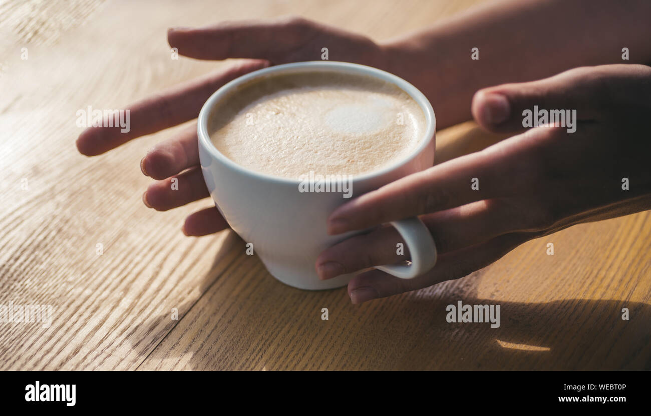 fresh morning coffee with milk and cream froth. relax in cafe or coffee ...