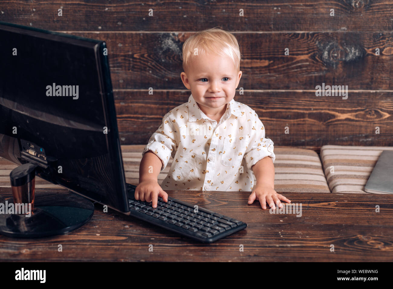 Genius child type computer keyboard. Genius toddler use new technology ...