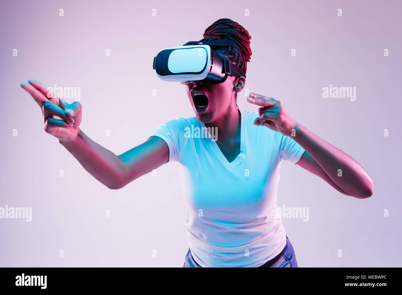 Portrait of young african-american woman's playing in VR-glasses in ...