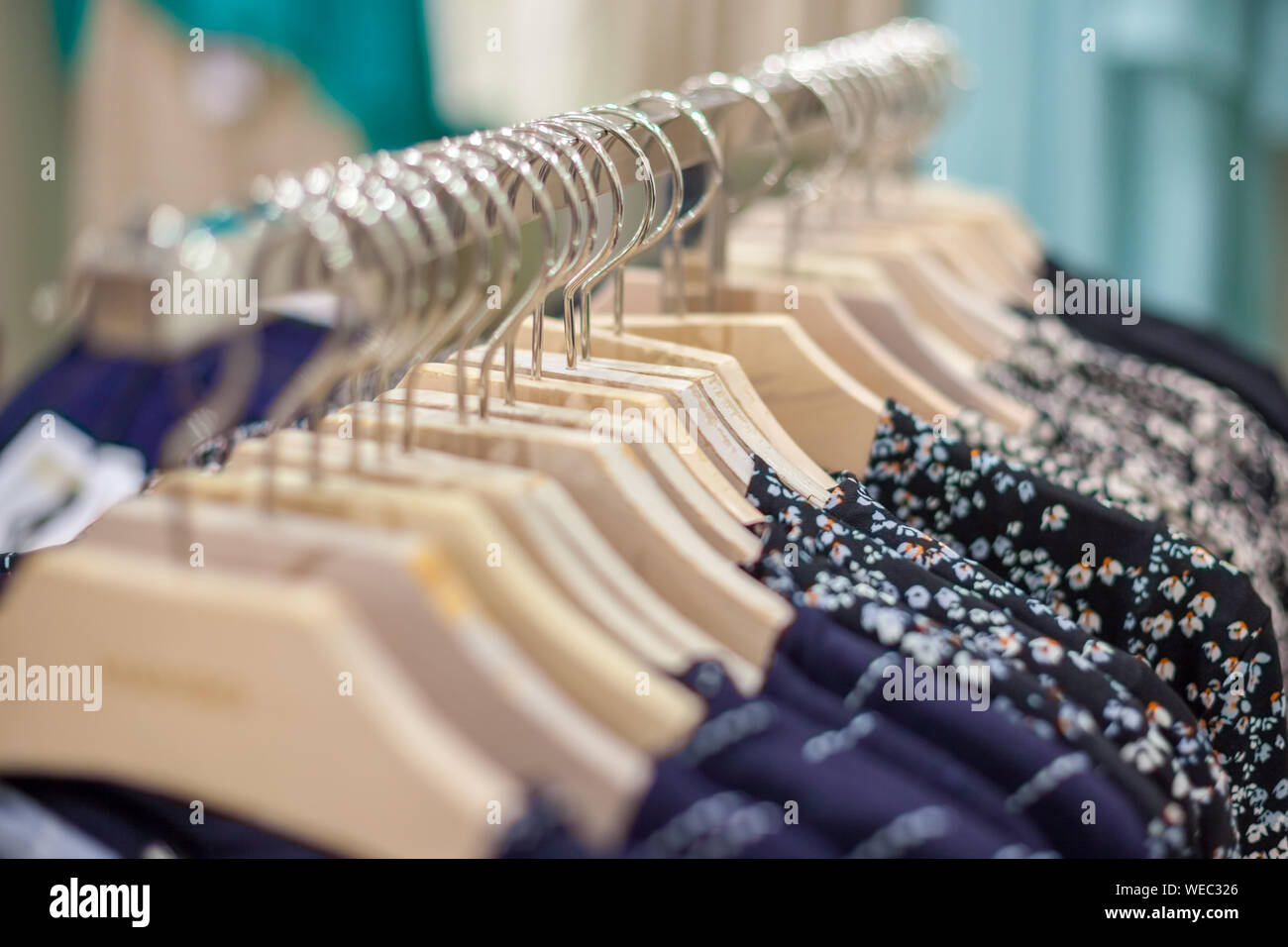 Clothes hang on a shelf. Clothes hanger showcase in store shopping ...