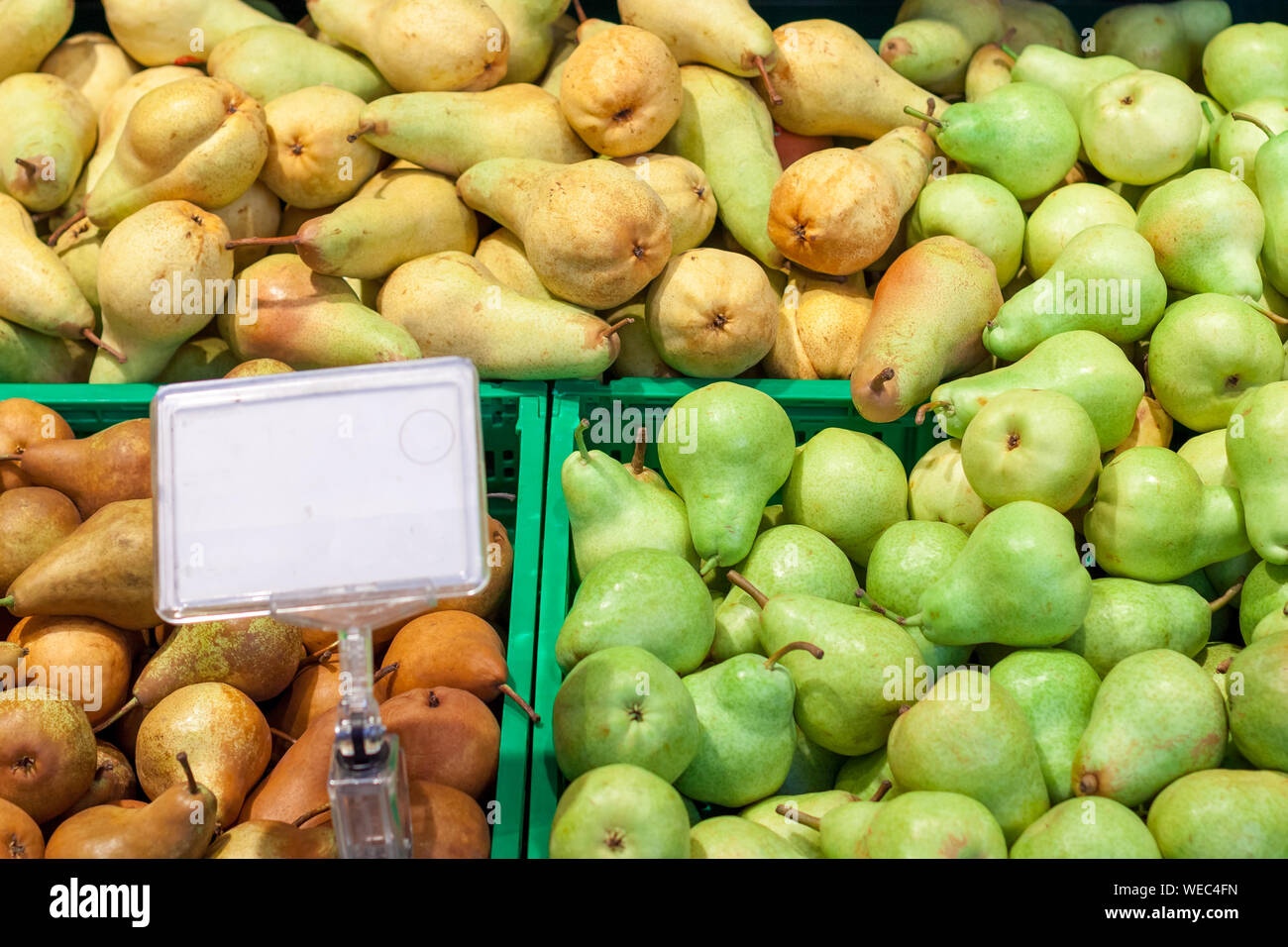 pears at the grocery store. lots of pears harvest collected in bins at ...