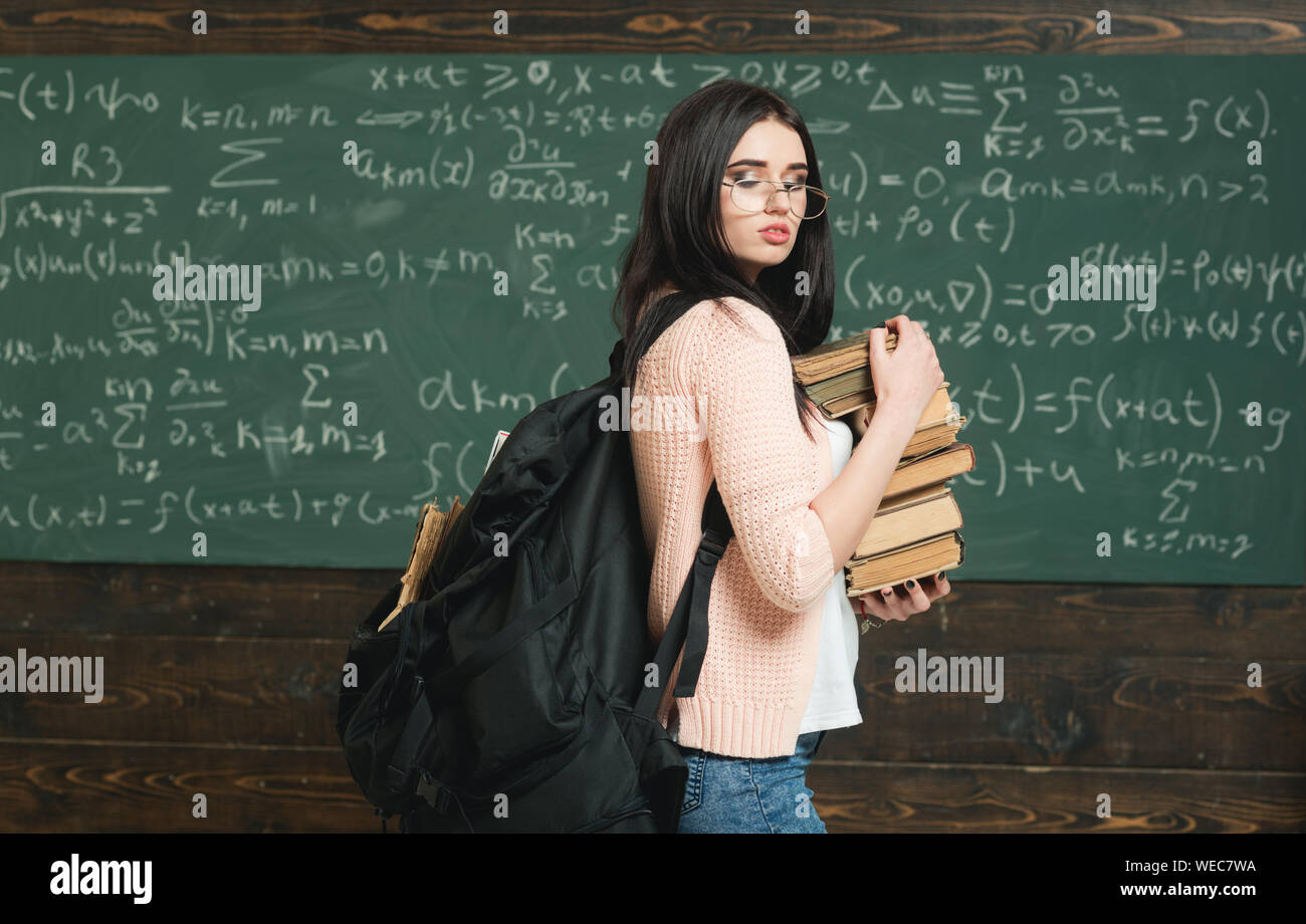 Girl With Big Backpack Holds Pile Books Chalkboard Background Girl