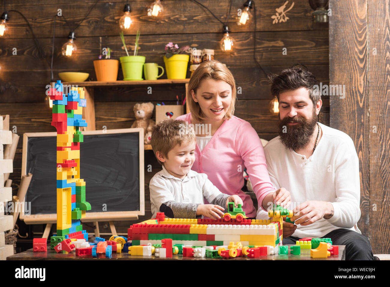 Family concept. Family build structure with toy bricks. Family play ...