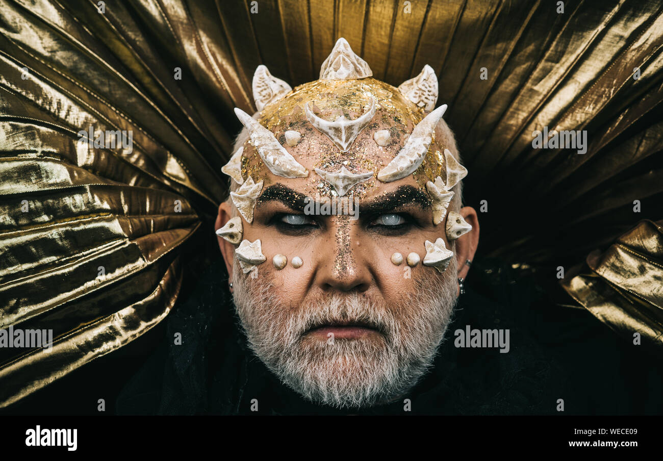 Demon rising from darkness. Monster with shining dragon skin and thorns ...