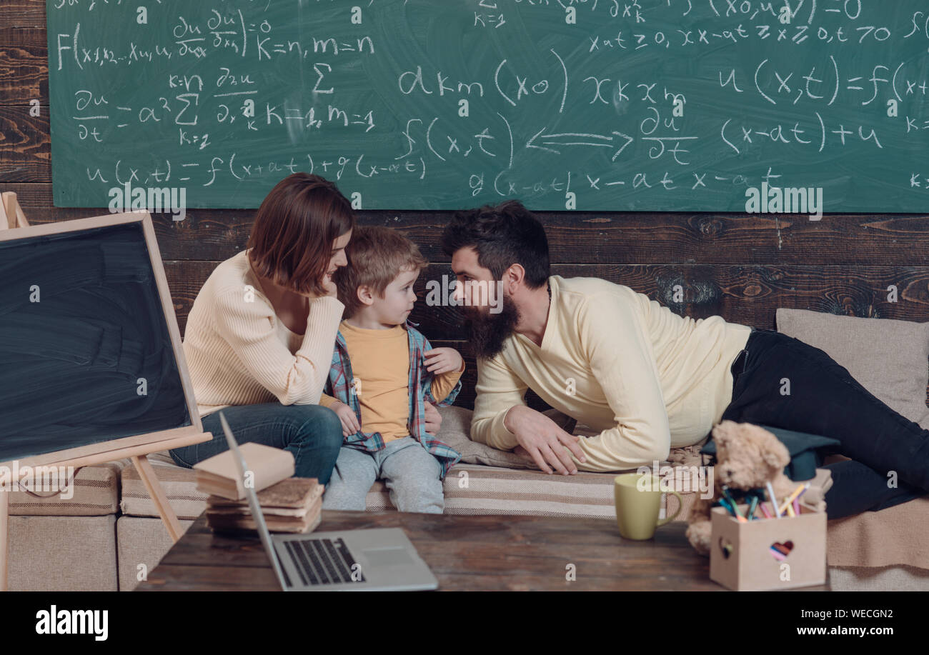 Homeschooling concept. Parents teaching kid, speaking. Boy listening to ...