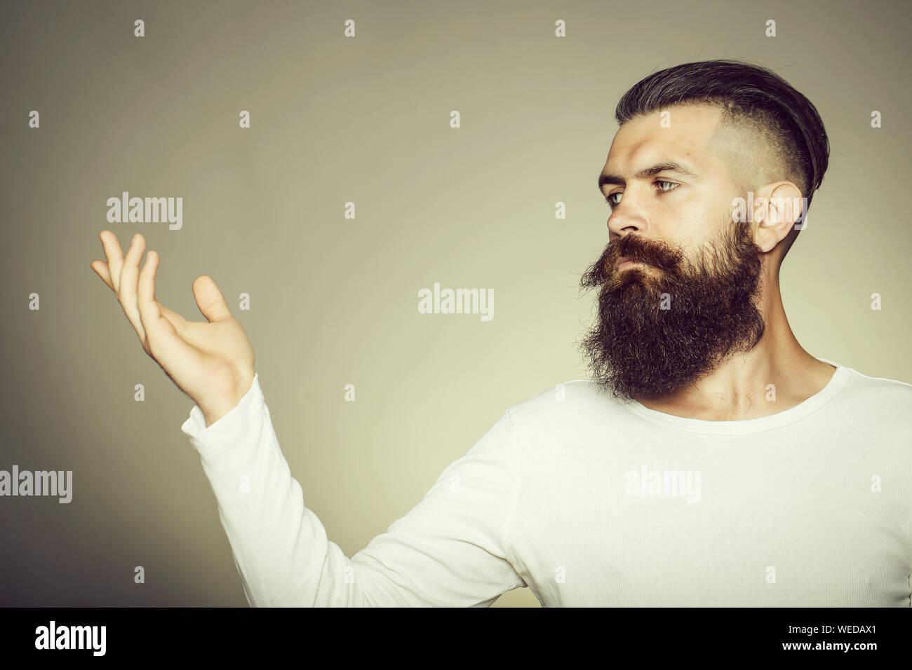 Bearded man with raised hand Stock Photo - Alamy