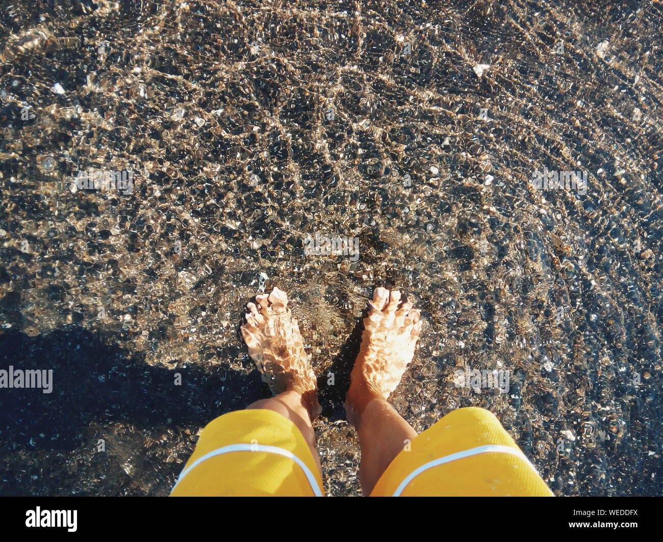 Man standing in shallow water hi-res stock photography and images - Alamy
