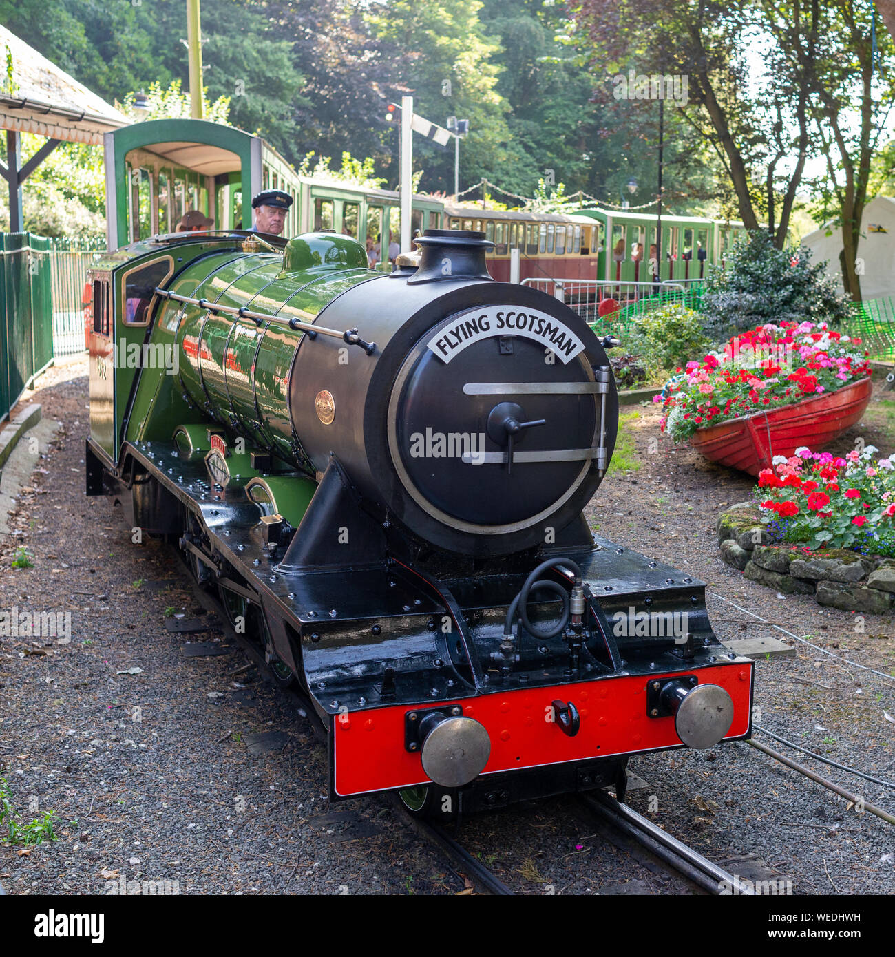 People riding a Flying Scotsman steam train replica on the miniature ...