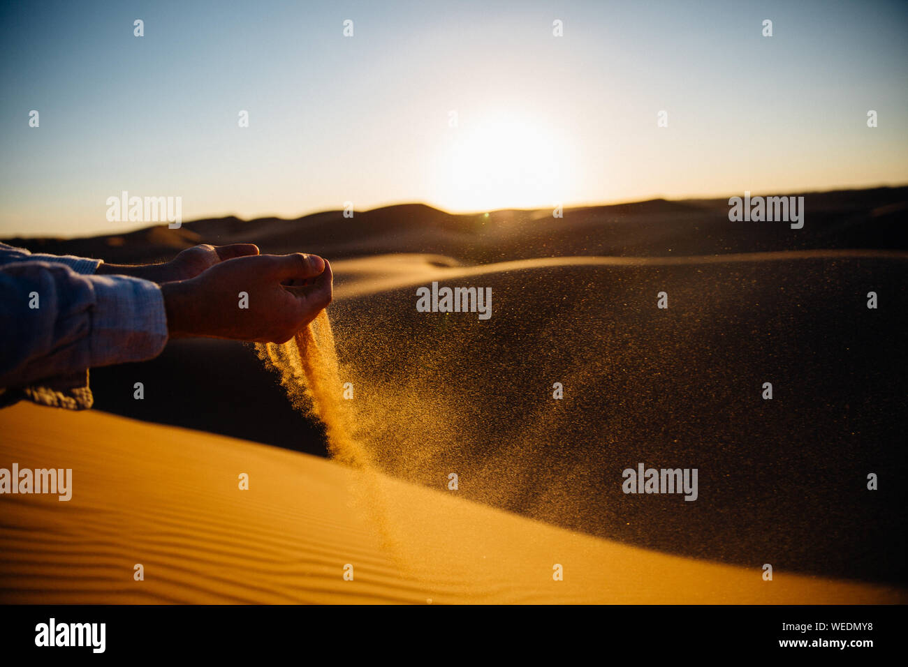 Hand pouring sand hi-res stock photography and images - Alamy