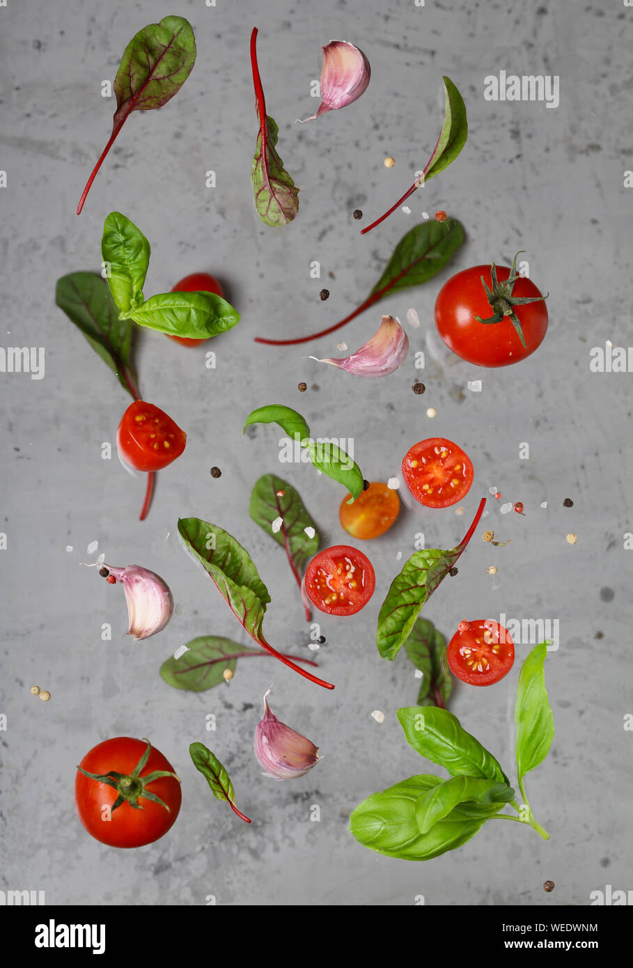 flying vegetables and herbs for salad Stock Photo - Alamy