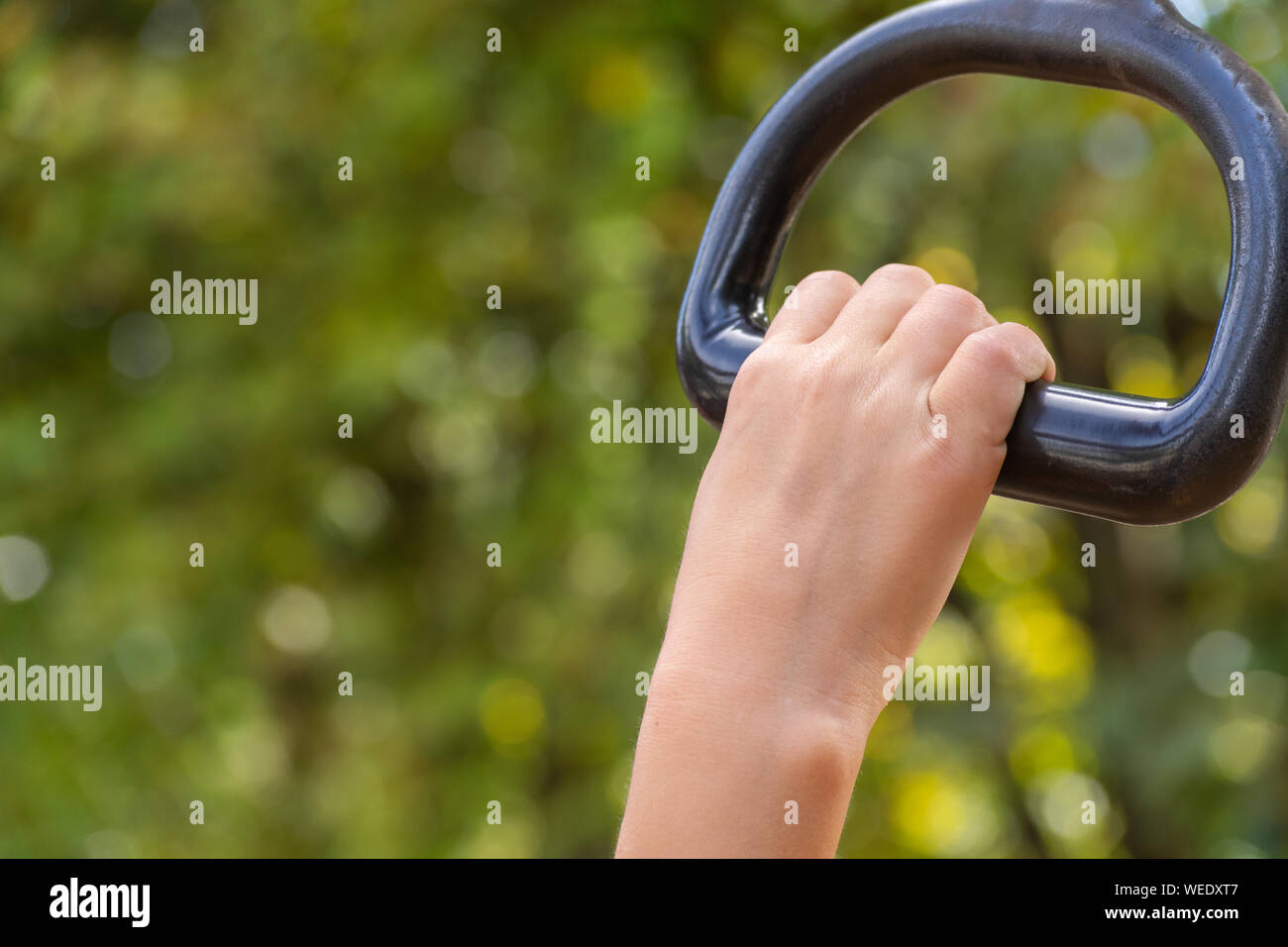 Child's hand grabbing a monkey bar at a playground conecept holding on ...