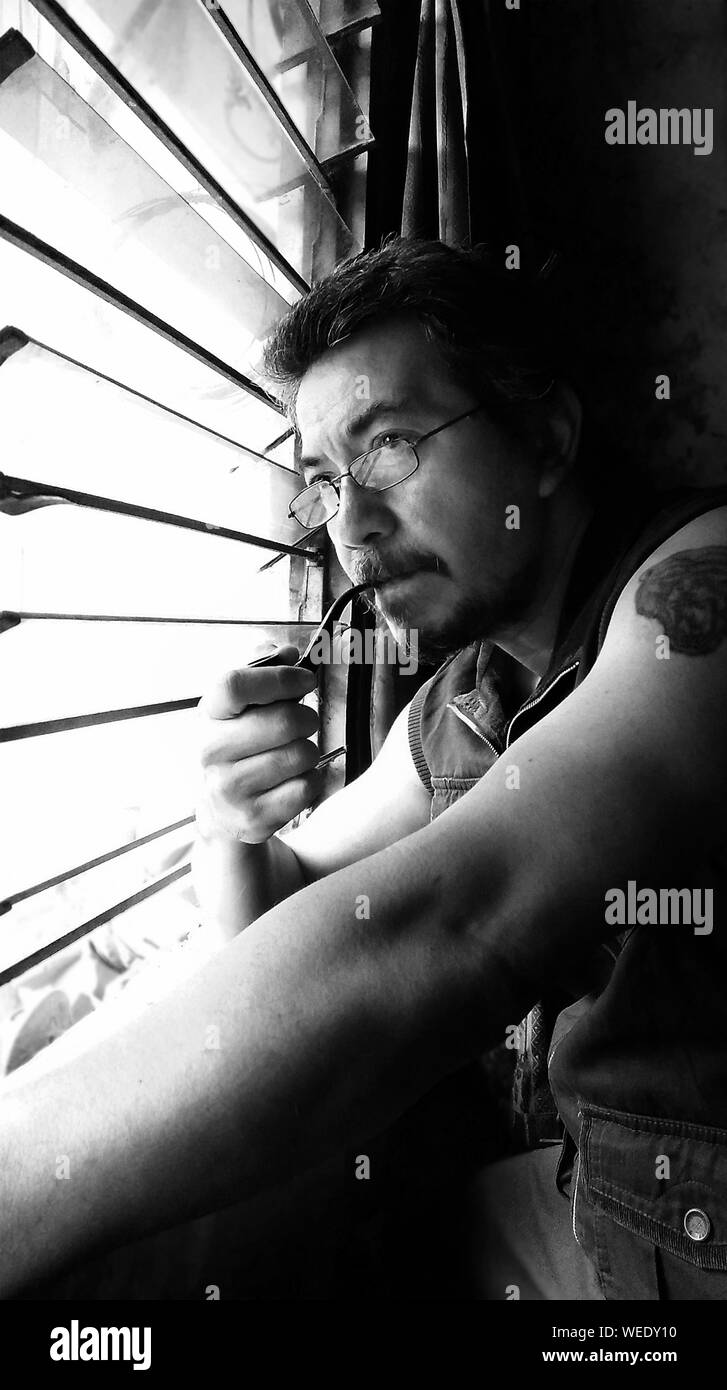 Smoking man at the window Black and White Stock Photos & Images - Alamy