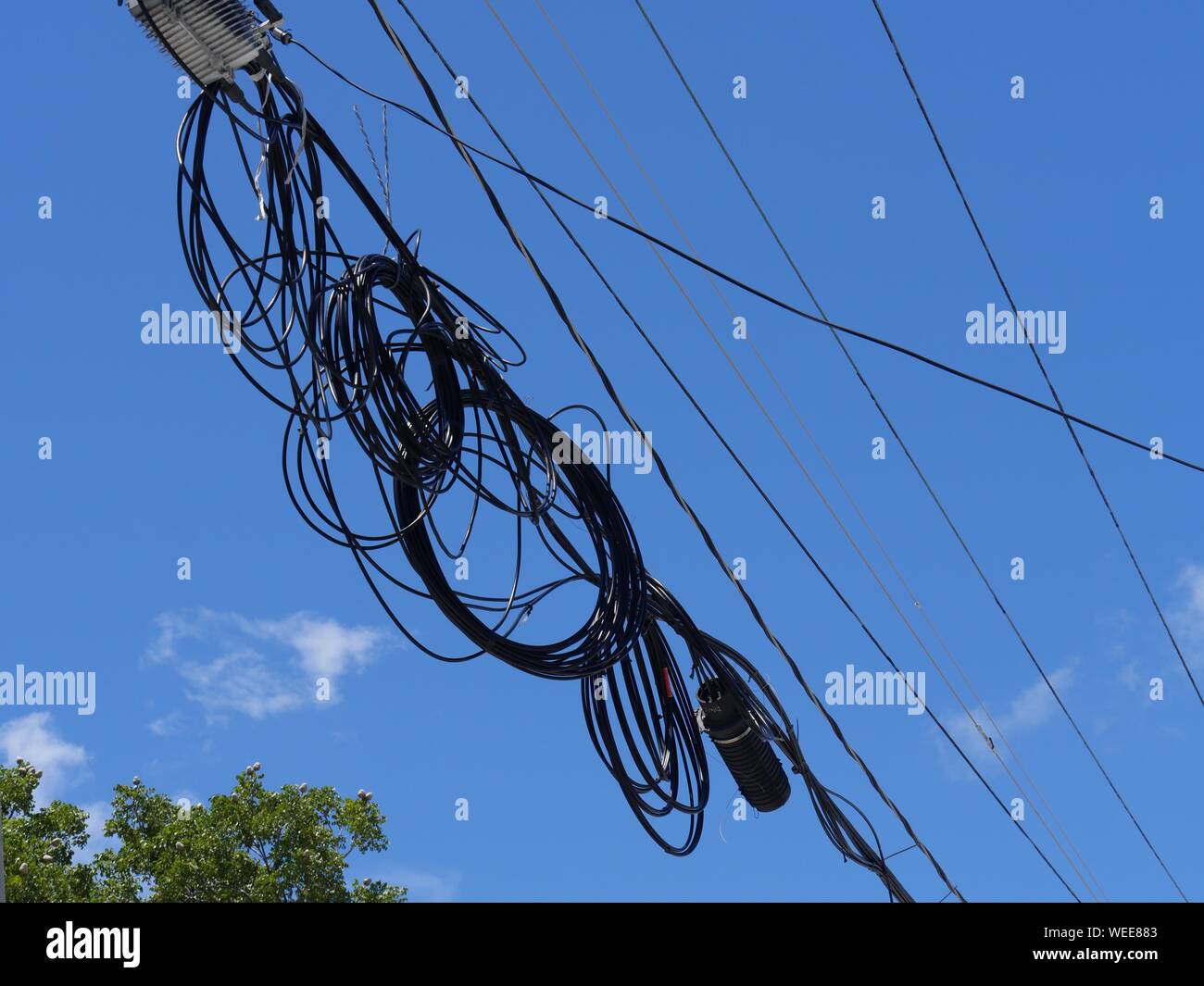 Hanging from power lines hi-res stock photography and images - Alamy
