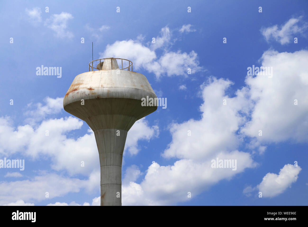 Water tower with clouds and blue sky background Stock Photo - Alamy
