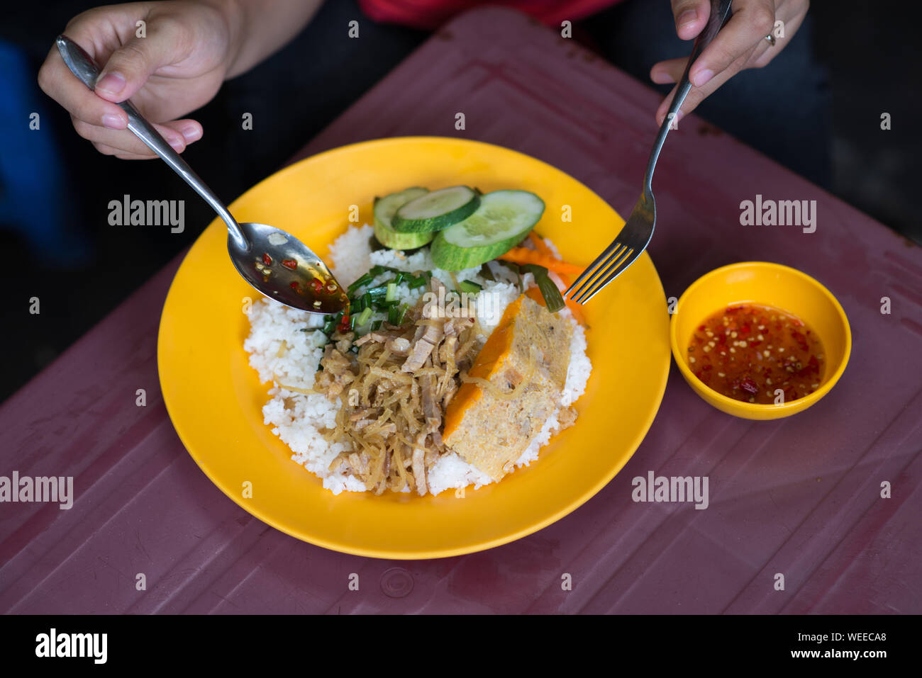 Human eating original Vietnamese com tam broken rice and meat Stock ...