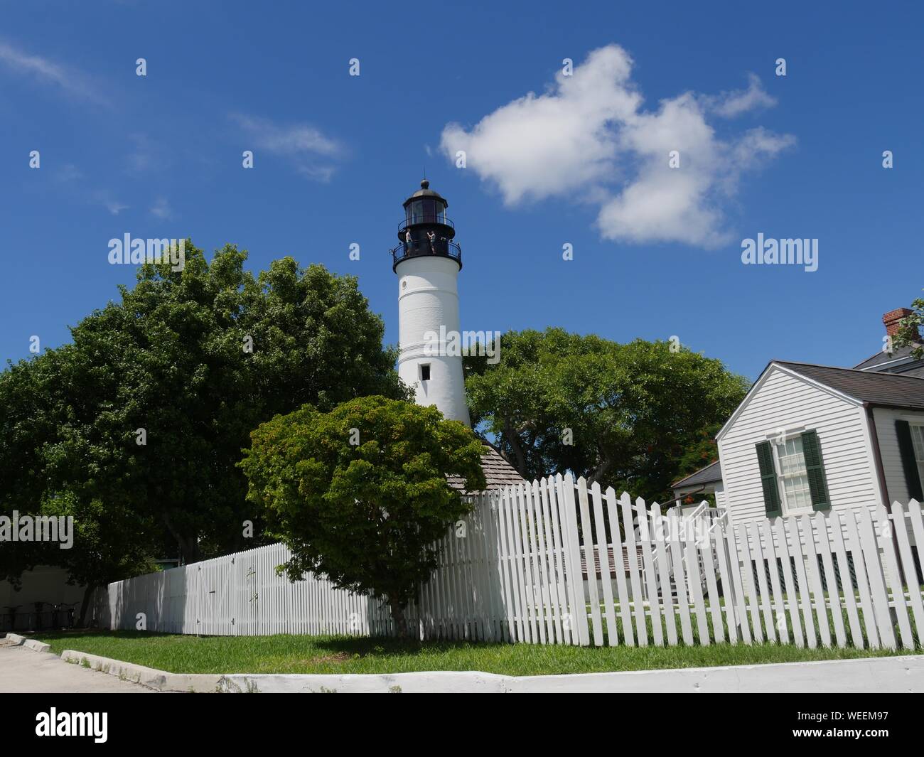 Wide shot of the Key West lighthouse and the keeper's quarters. The ...