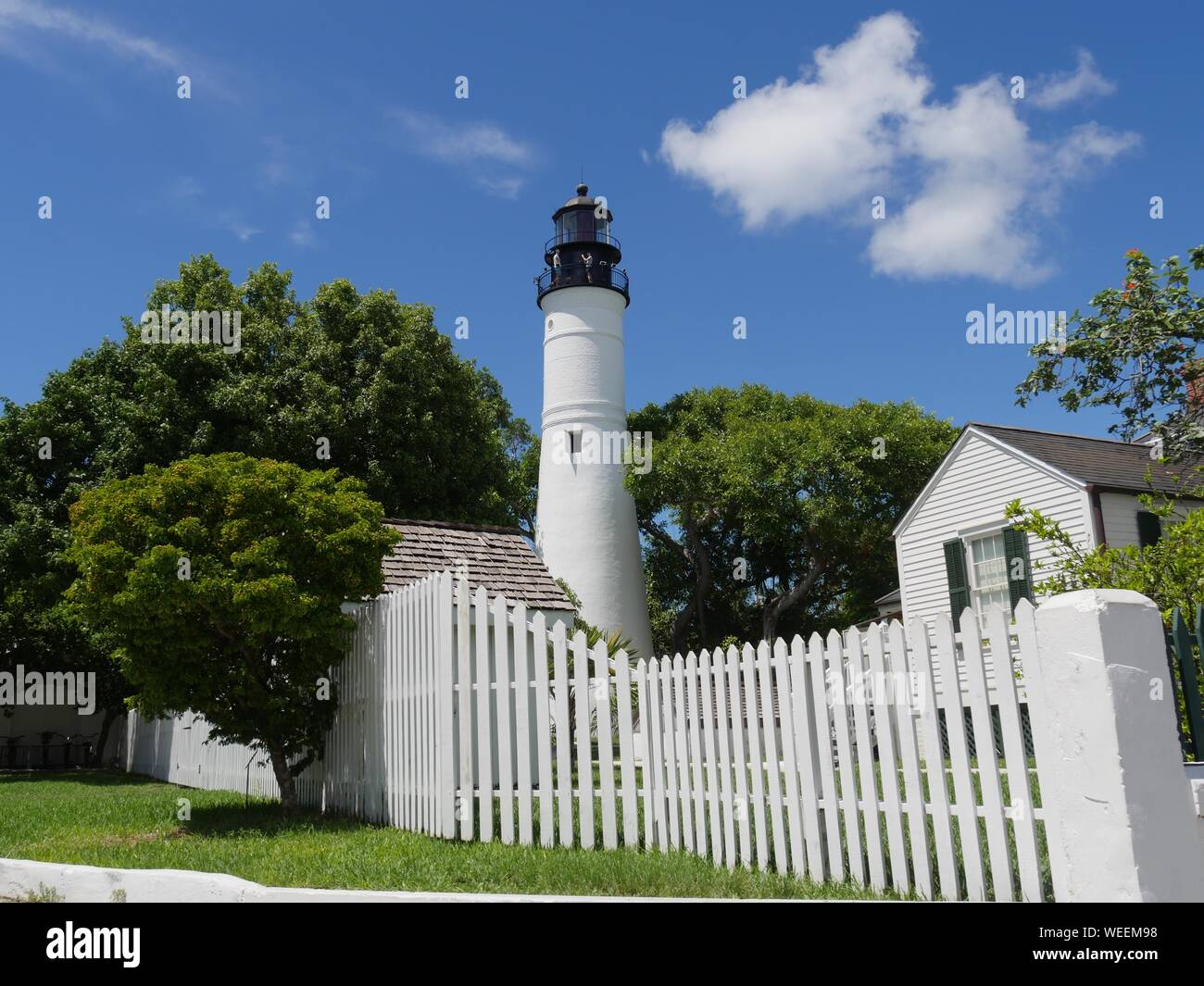 The Key West lighthouse and the keeper's quarters. The lighthouse is a ...