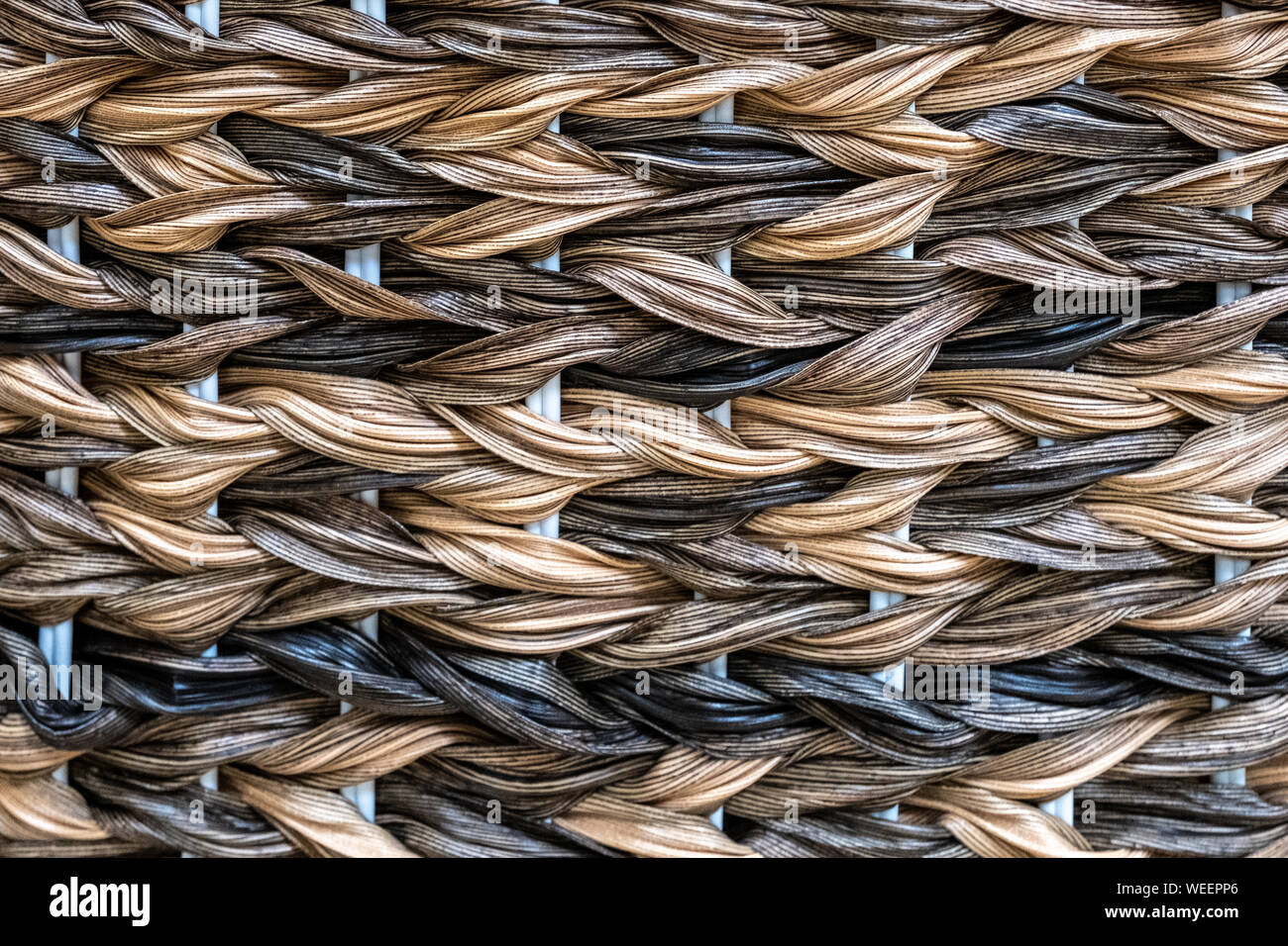 weaving from a colored vine. handmade wickerwork pattern Stock Photo ...